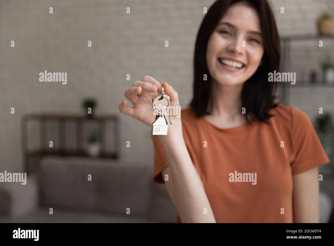 Happy young homeowner holding keys from new apartment Stock Photo - Alamy