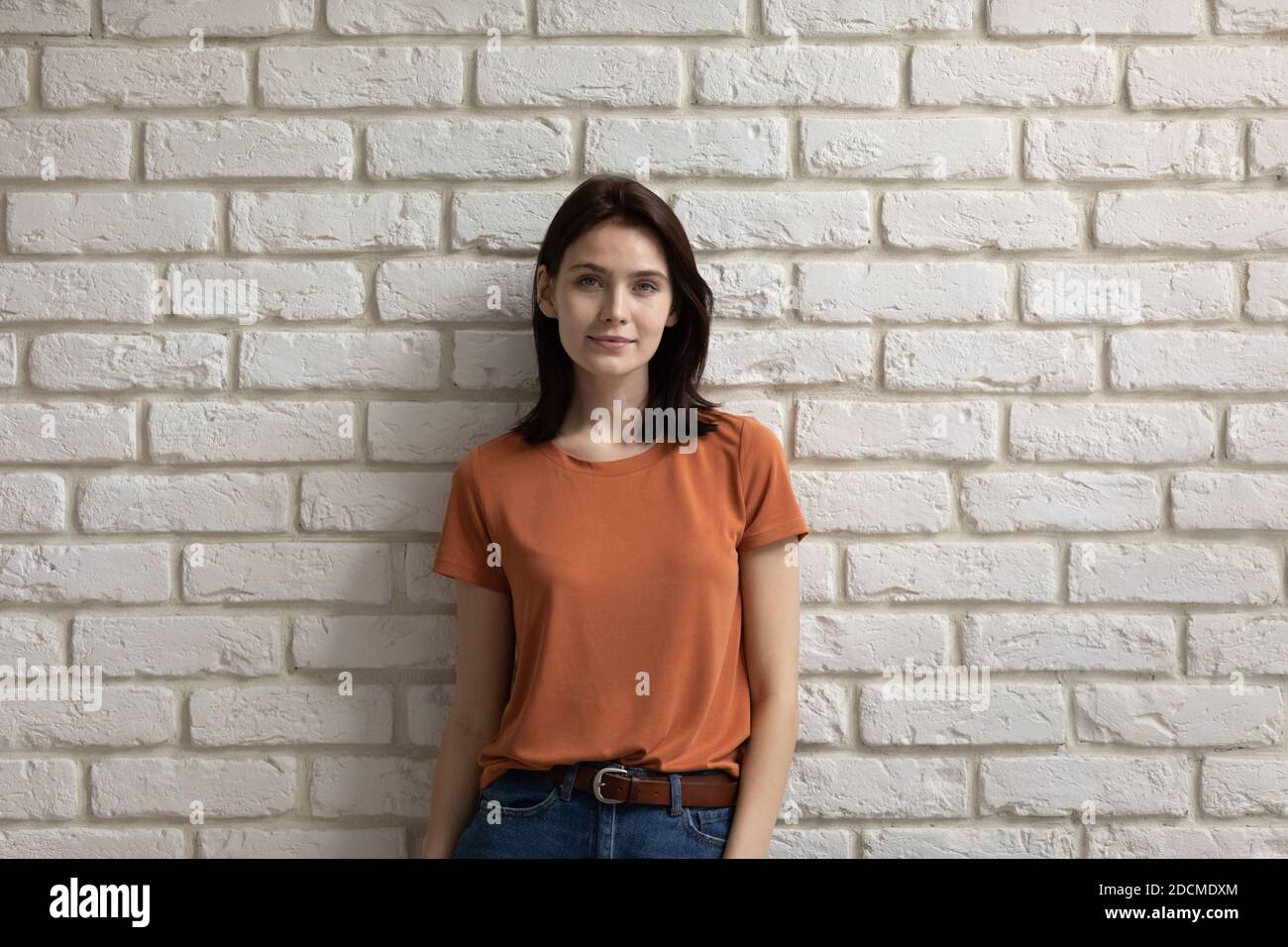 Attractive girl standing near wall hi-res stock photography and images ...