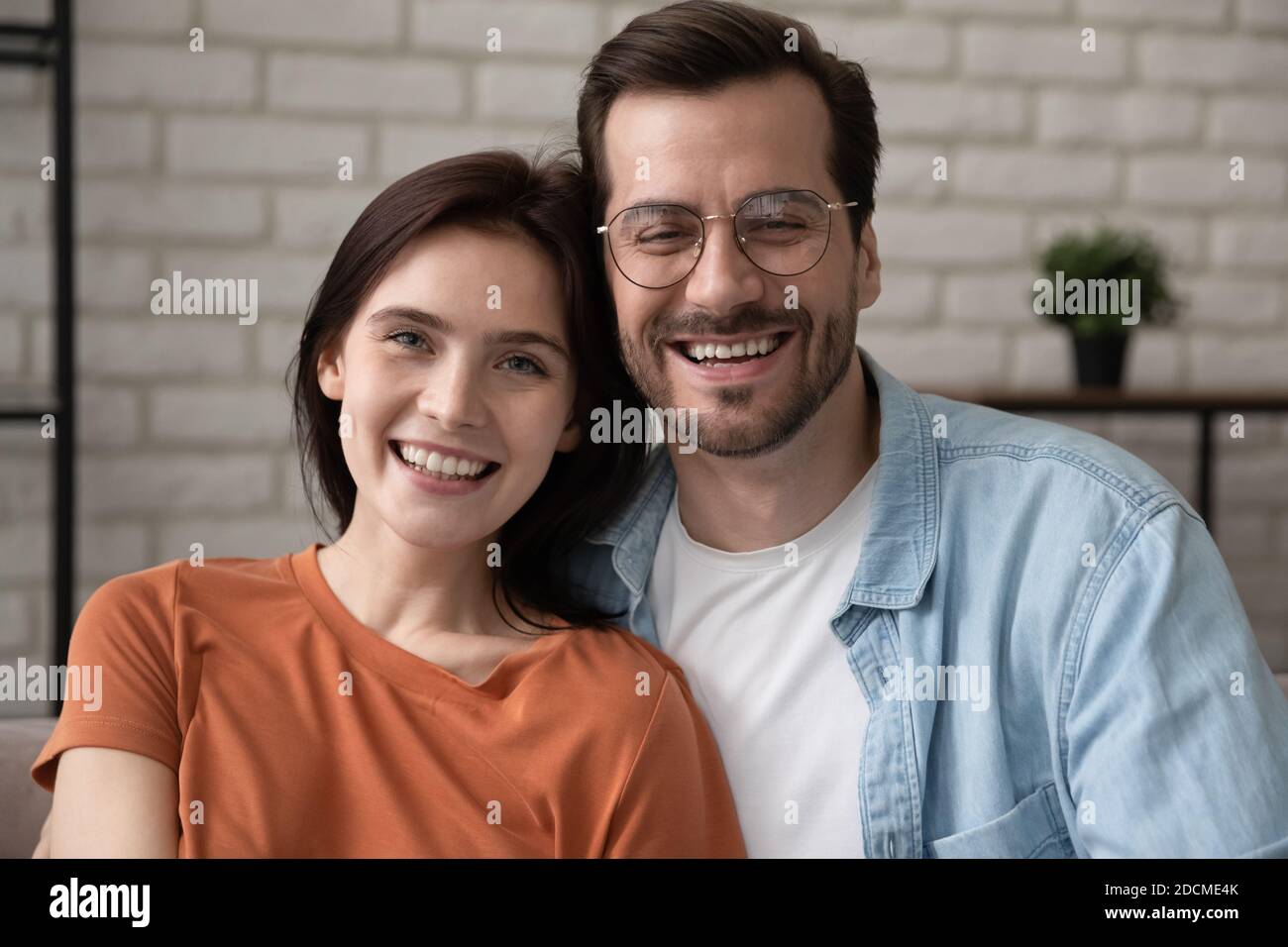 Portrait of happy loving affectionate millennial married family couple ...