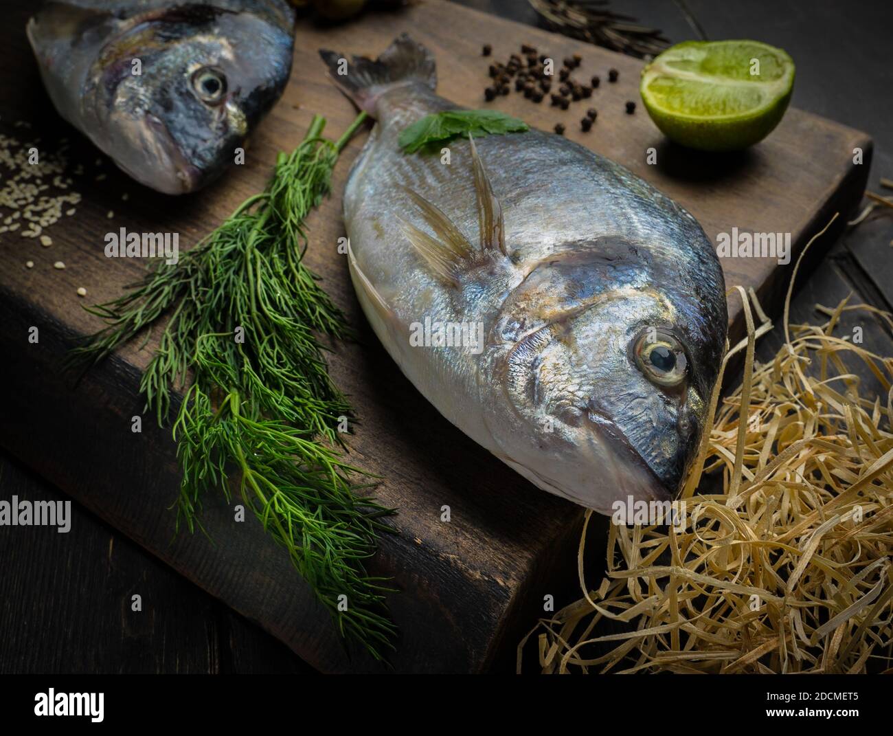 Fresh raw dorado fish on cutting board. Culinary seafood background ...