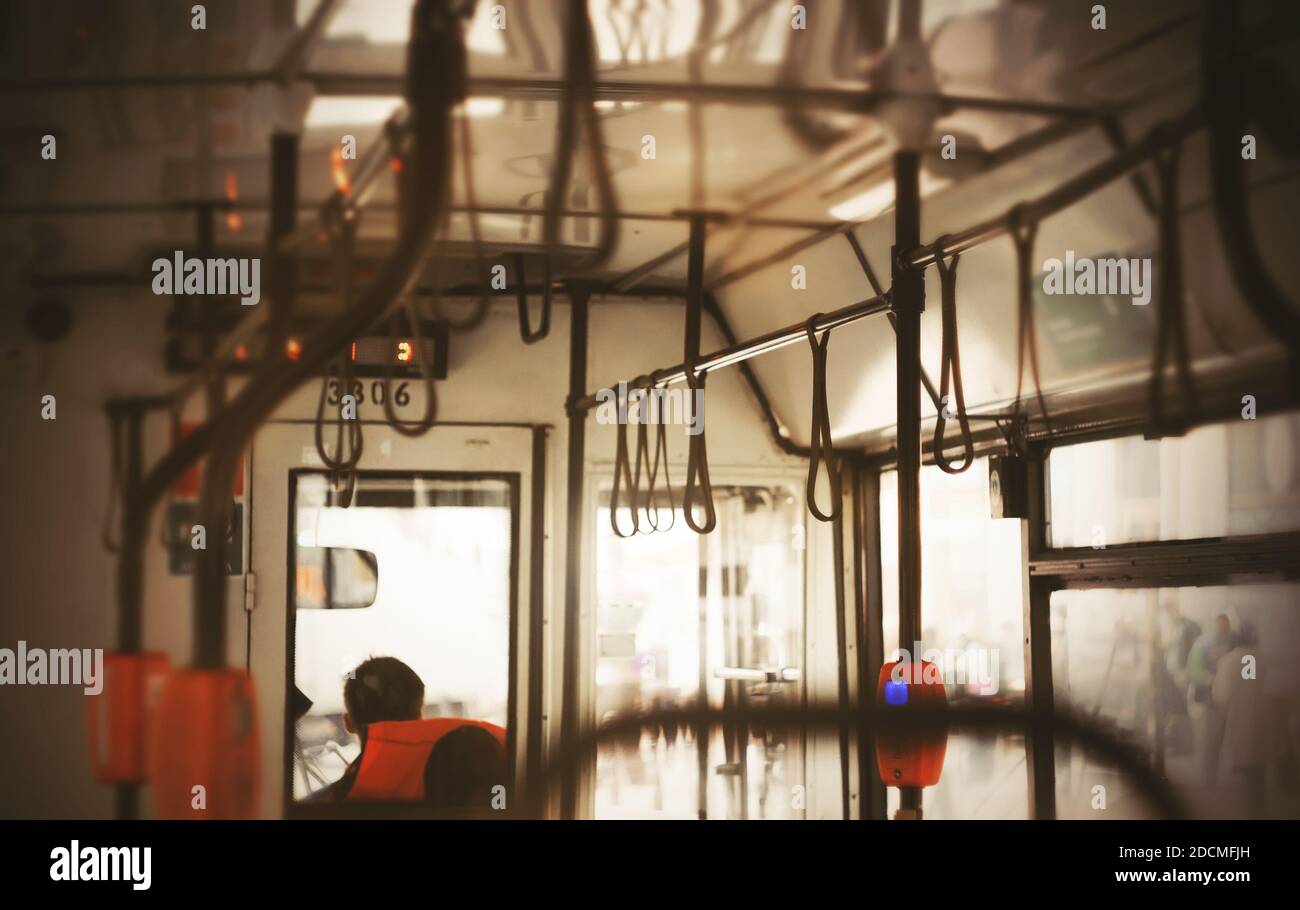 An empty passenger compartment of a public bus from the inside, with ...