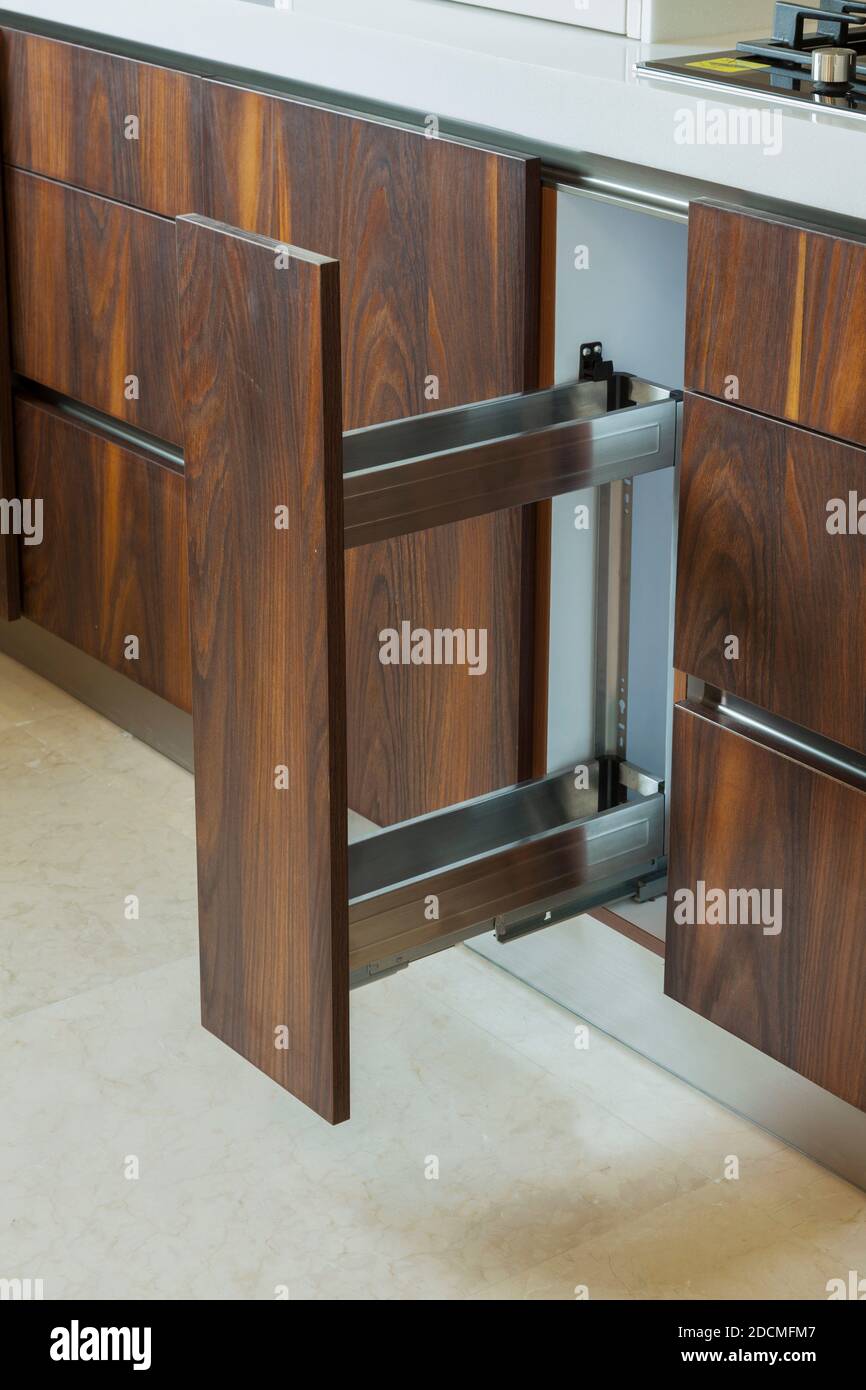 Modern kitchen, open wooden drawers with accessories inside, solution ...