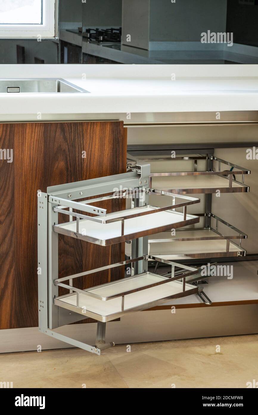 Modern kitchen, open wooden drawers with accessories inside, solution ...