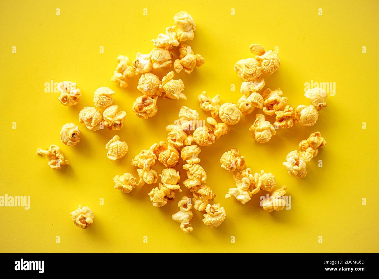 Popcorn on yellow background with copy space Stock Photo - Alamy