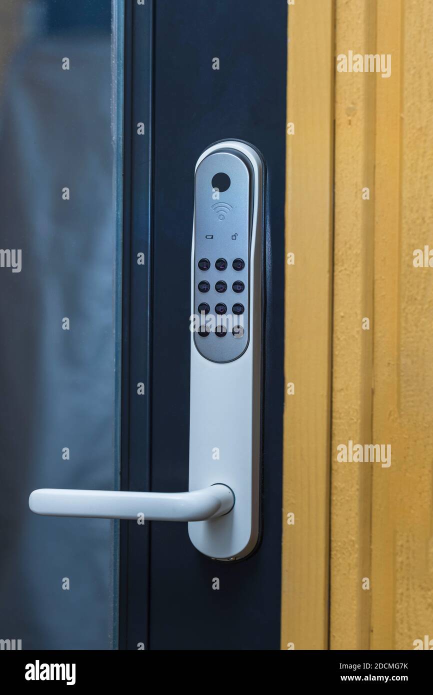 Close up view of an electric combination lock on a white door. Interior ...