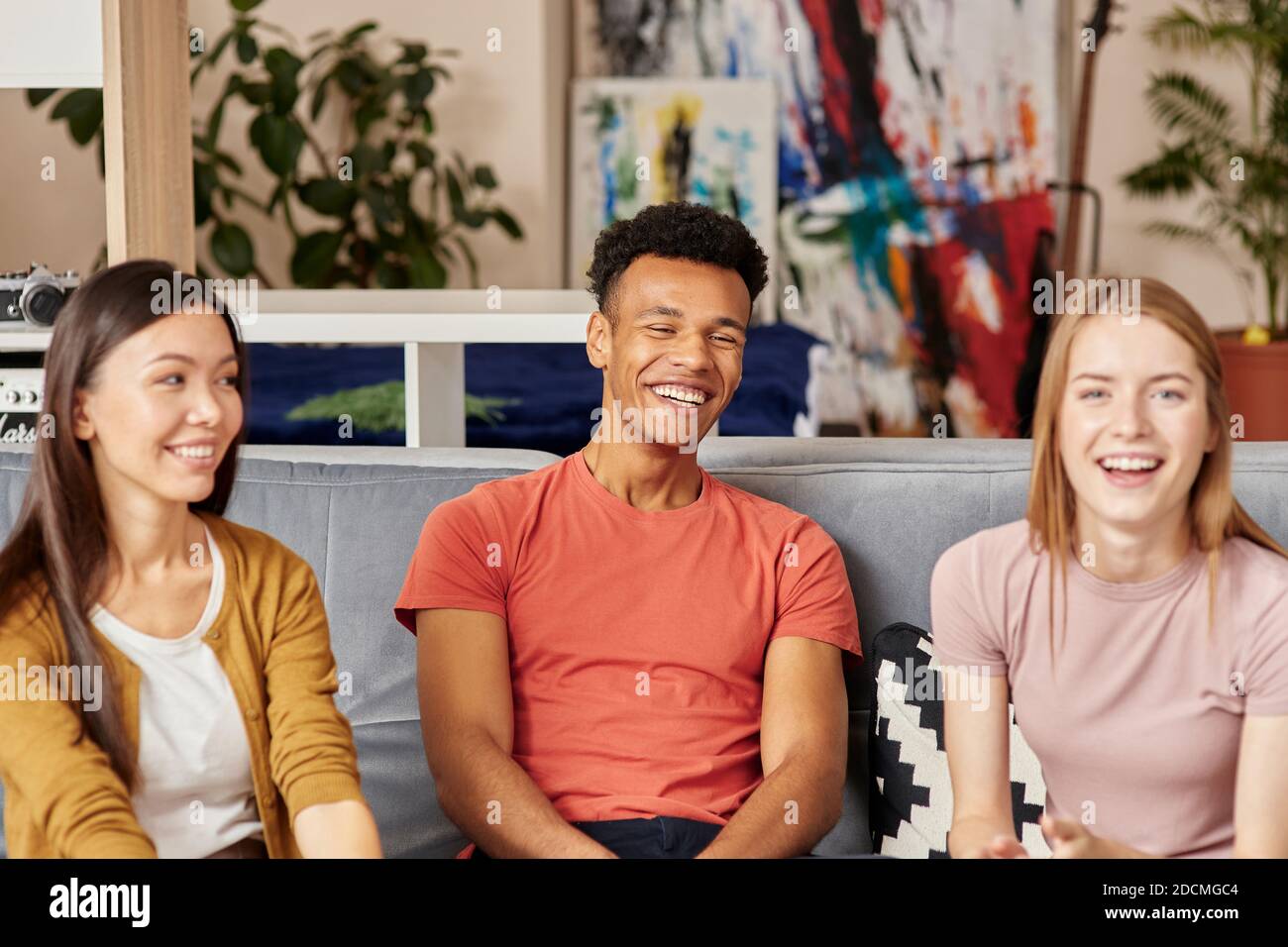 True friends. Young multicultural people in casual wear chatting and ...