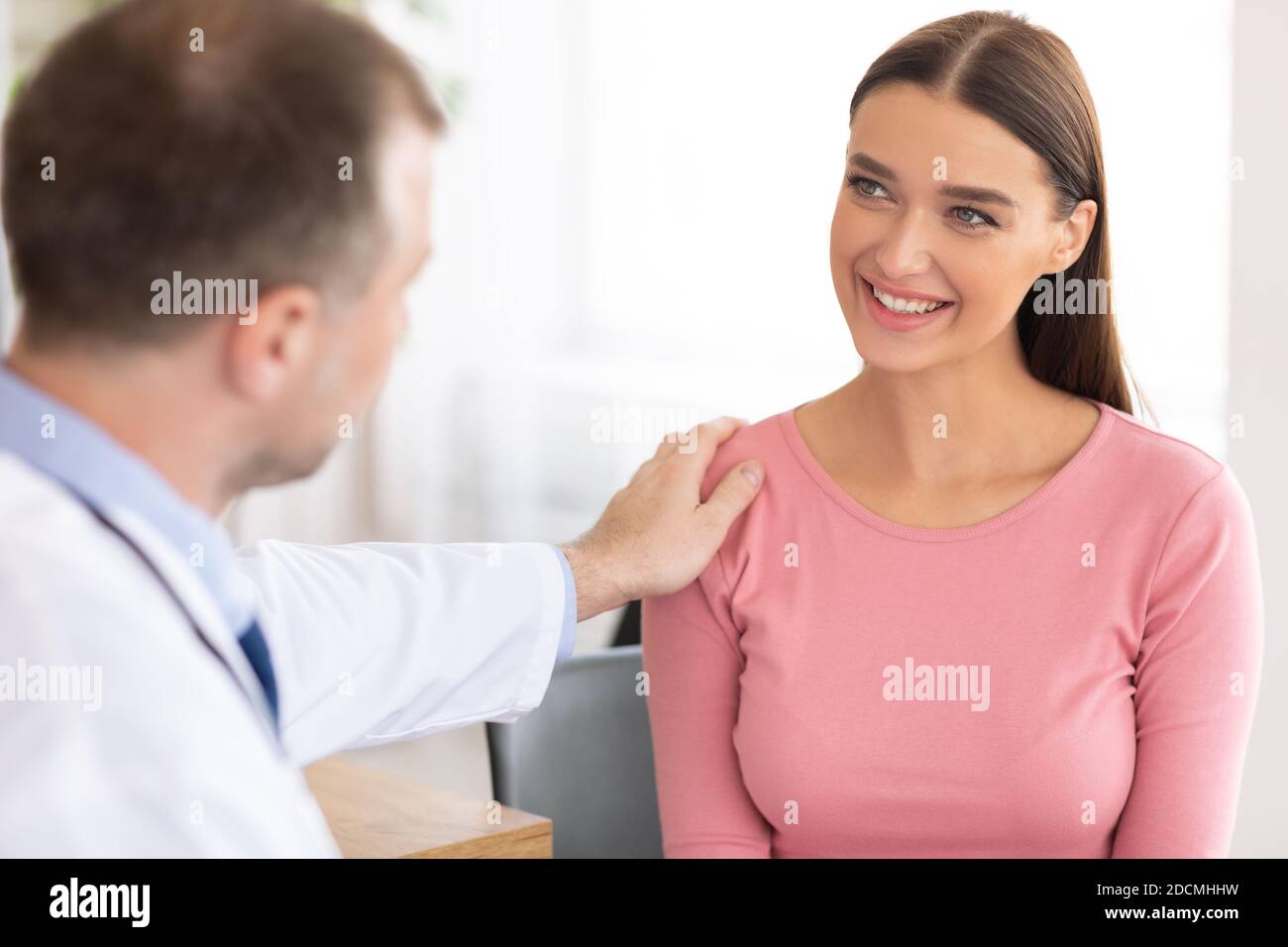 Male doctor telling good news to his female patient Stock Photo - Alamy