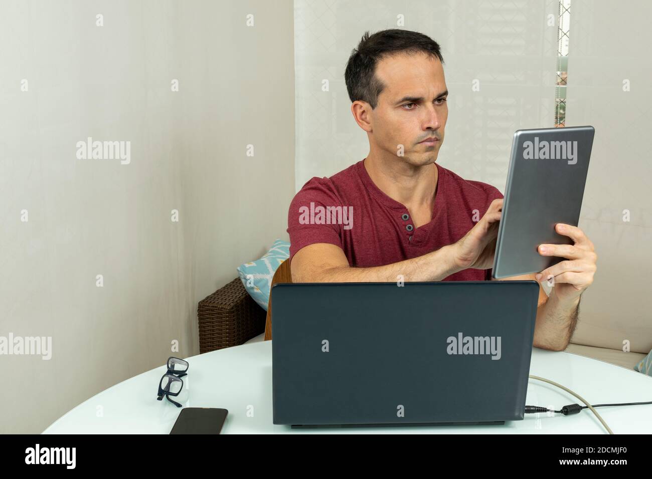 44 year old man doing home office with computer and tablet (photo 2 ...