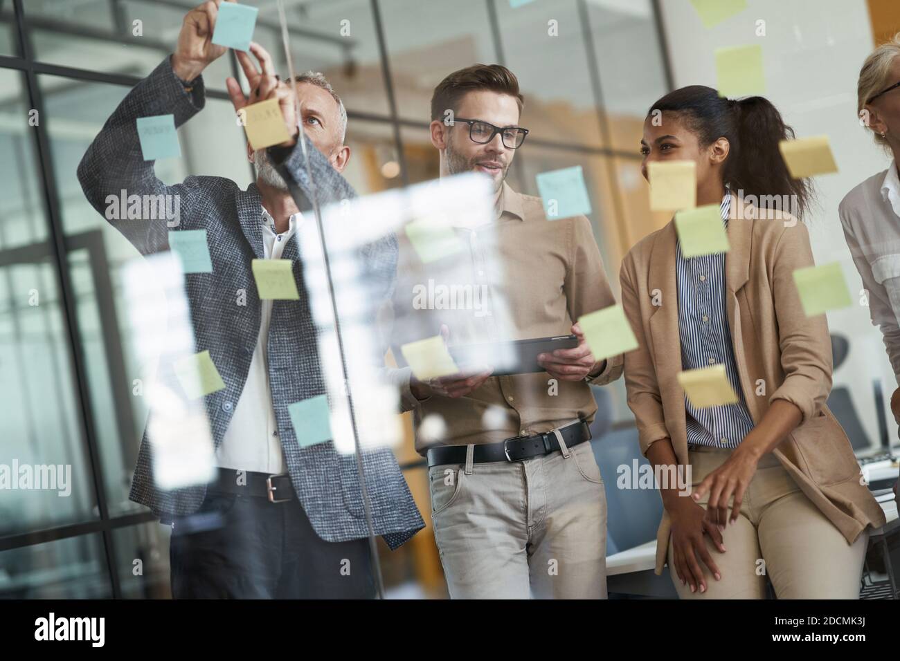 Group of multiracial coworkers standing in the modern office and ...