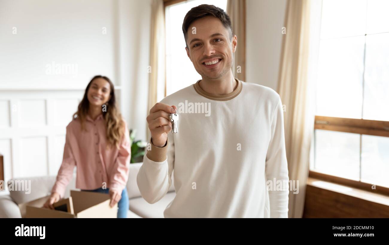 Married couple at moving day showing keys feels happy Stock Photo - Alamy