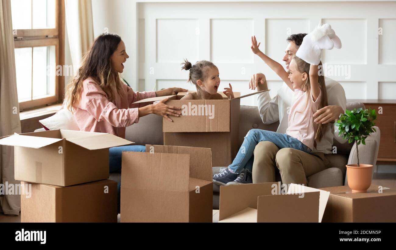 Family celebrate relocation day playing with little kids feeling ...