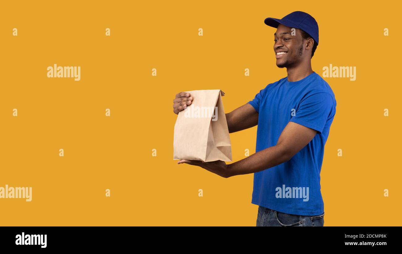 Black delivery man holding package hi-res stock photography and images ...