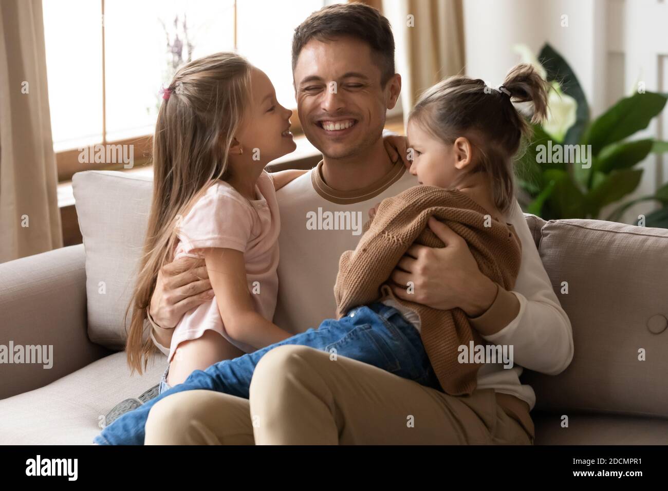 Dad hugs two daughters feels happy spend time together Stock Photo - Alamy