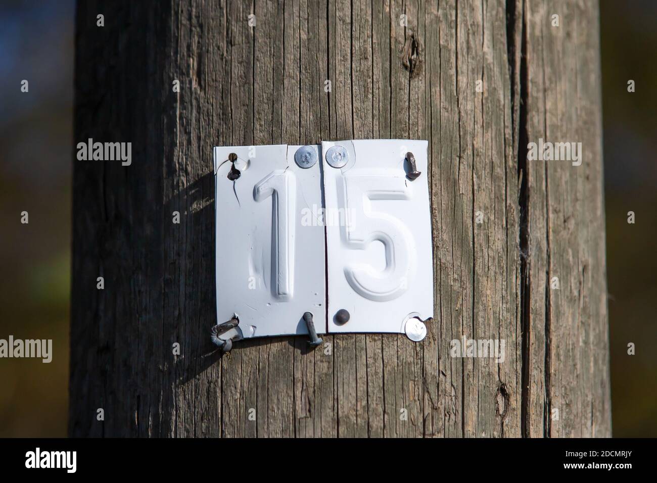 sheet metal with the number 15 on a wooden mast, outdoors Stock Photo ...