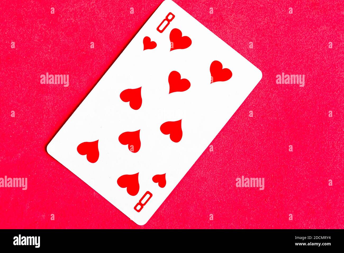Eight of Hearts playing card, red background Stock Photo - Alamy