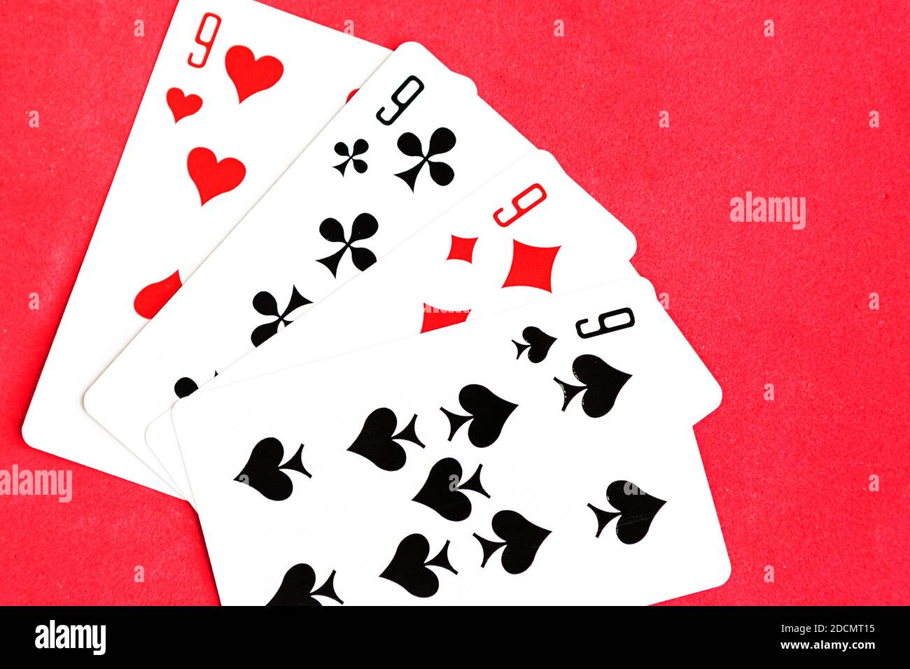 Poker quads playing card, red background Stock Photo - Alamy