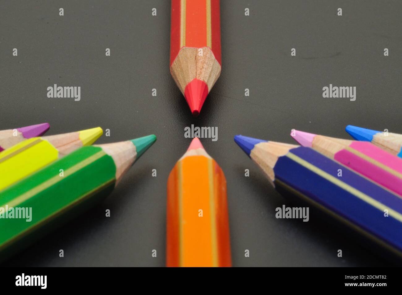 Bullying metaphor with color pencils pointing to red one over black ...