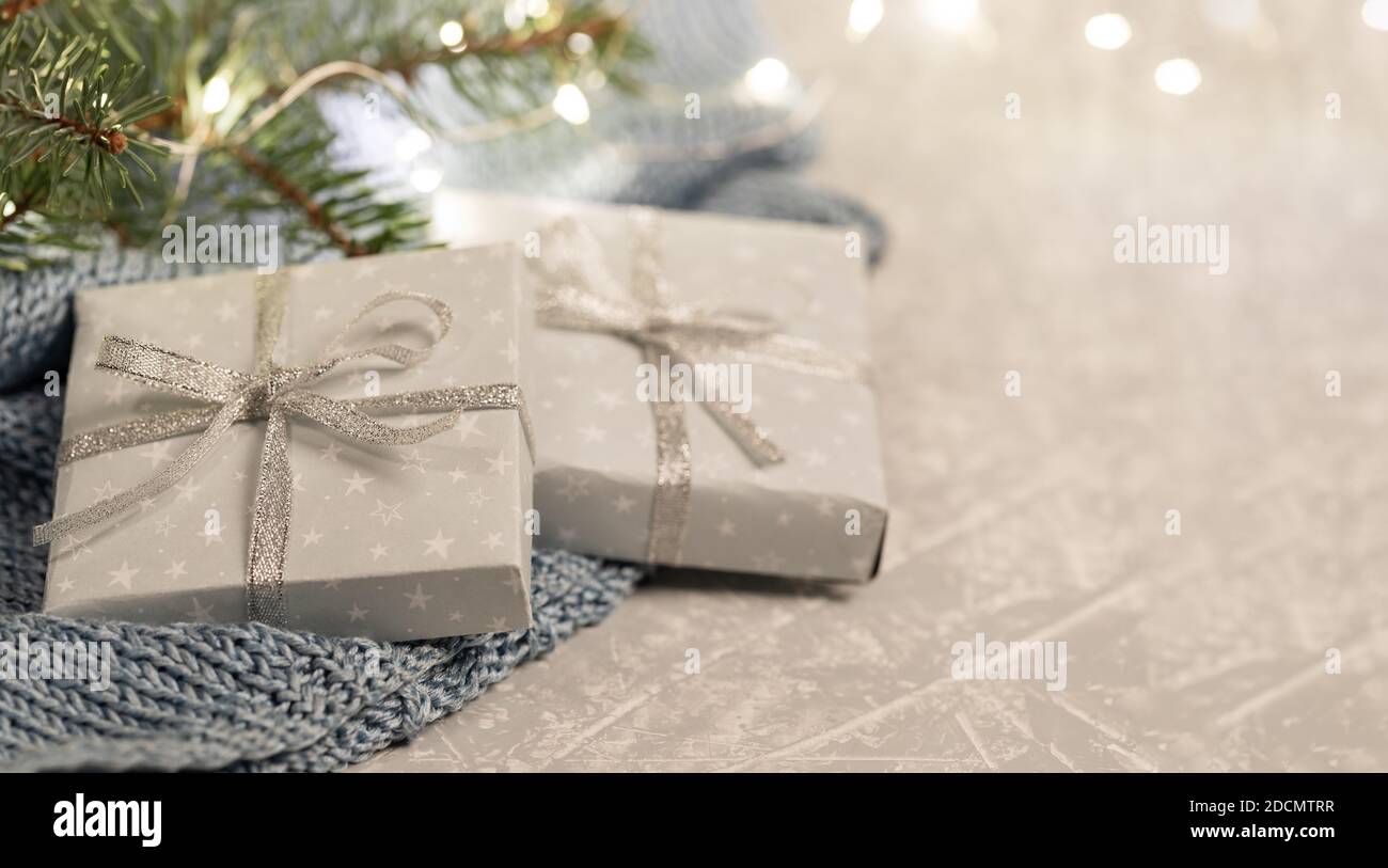 Two DIY gift boxes on grey knitted plaid with fir branches and Xmas ...