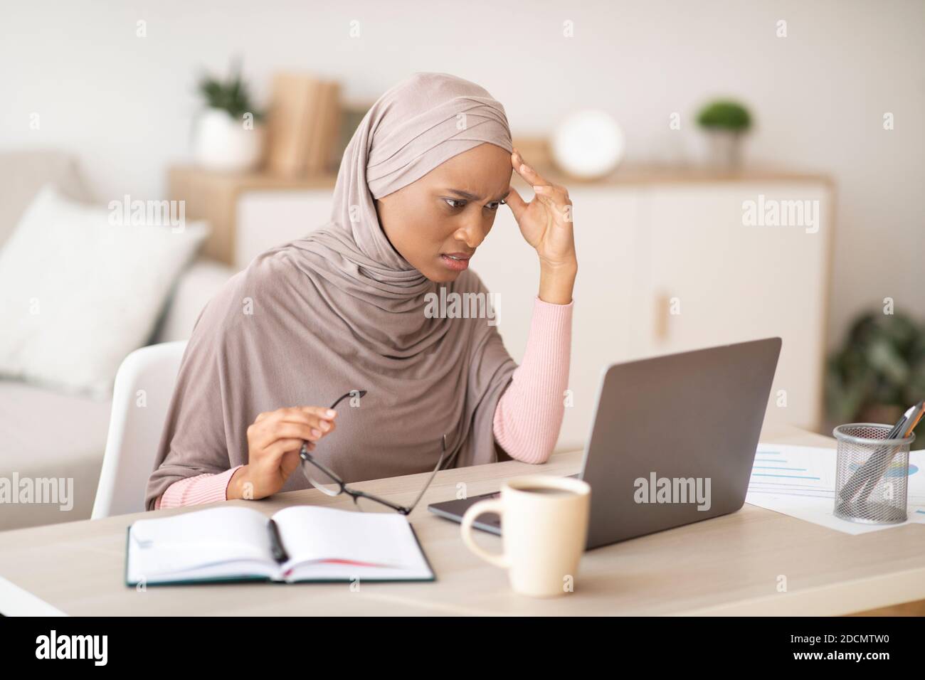 Tired black woman in hijab failing to meet deadline, having difficulty ...