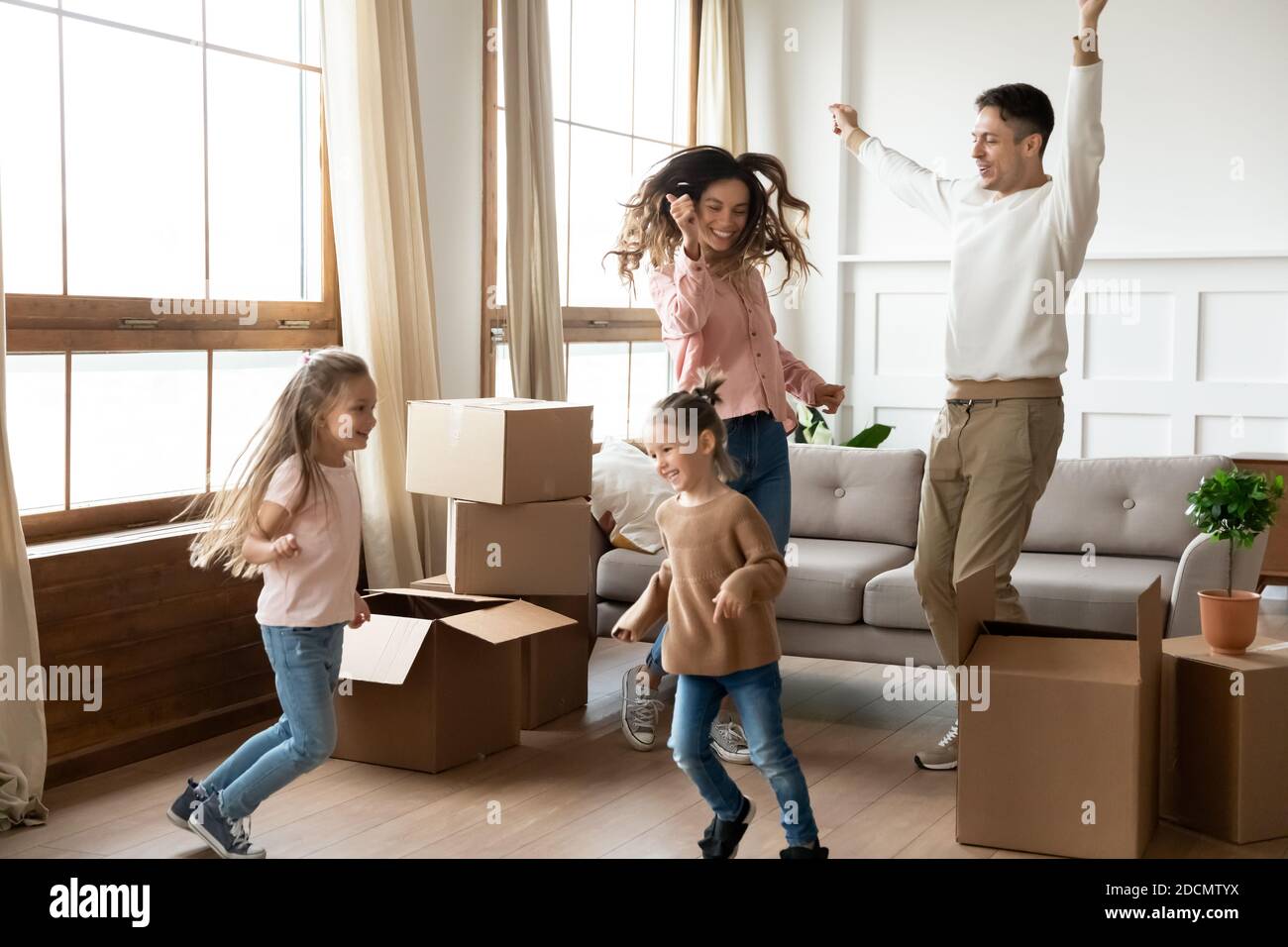 Happy family dancing indoor celebrate moving day to new home Stock ...