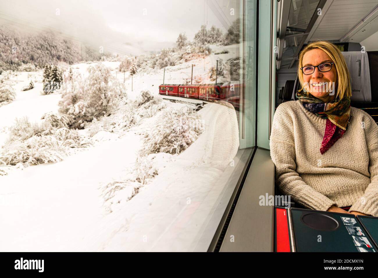 Atmospheric journey with the Rhaetian Railway. Train ride through snowy ...