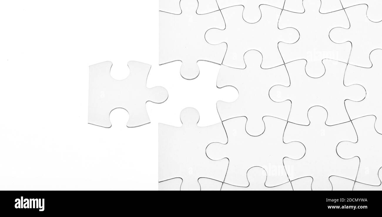 White jigsaw puzzle pattern background. placing last piece of jigsaw ...