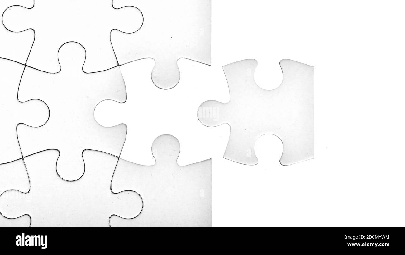 White jigsaw puzzle pattern background. placing last piece of jigsaw ...