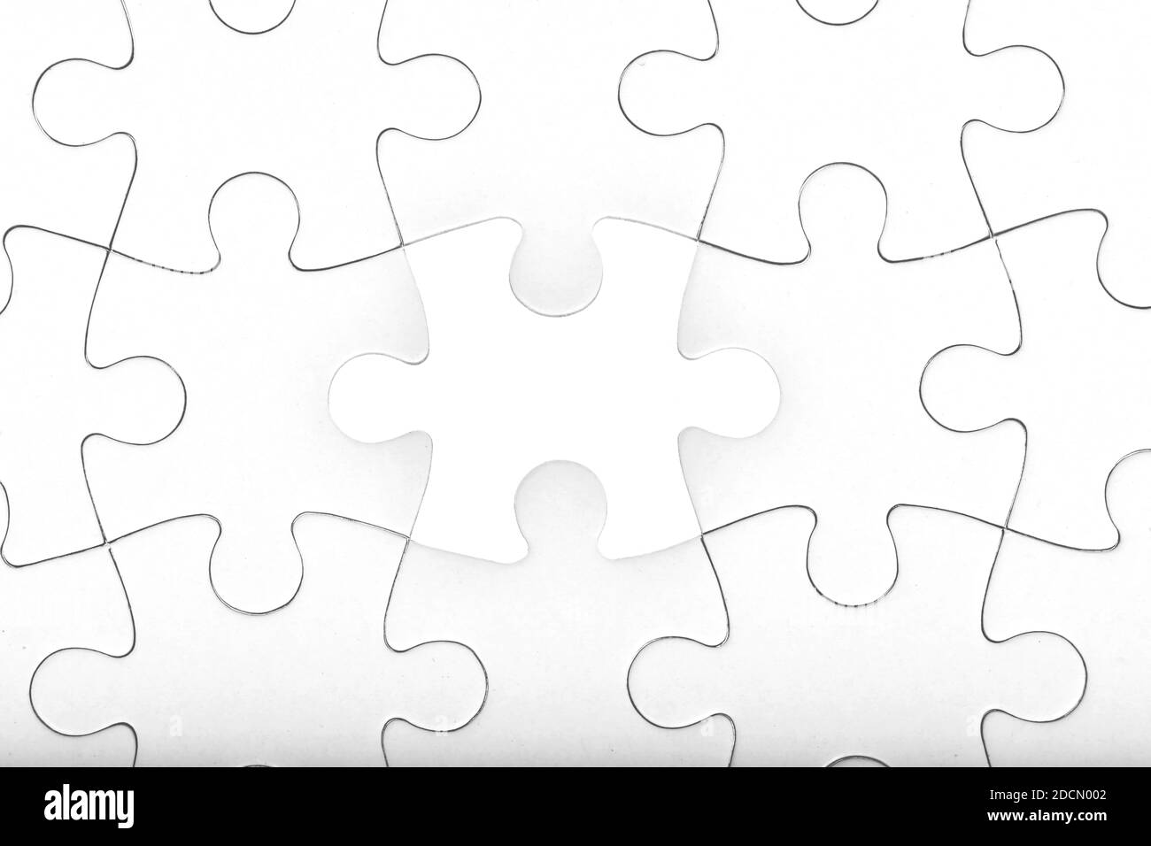 White jigsaw puzzle pattern background. placing last piece of jigsaw ...