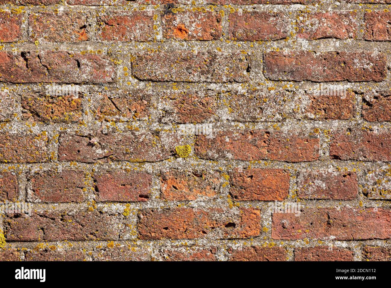 A wall of red with damaged bricks Stock Photo - Alamy