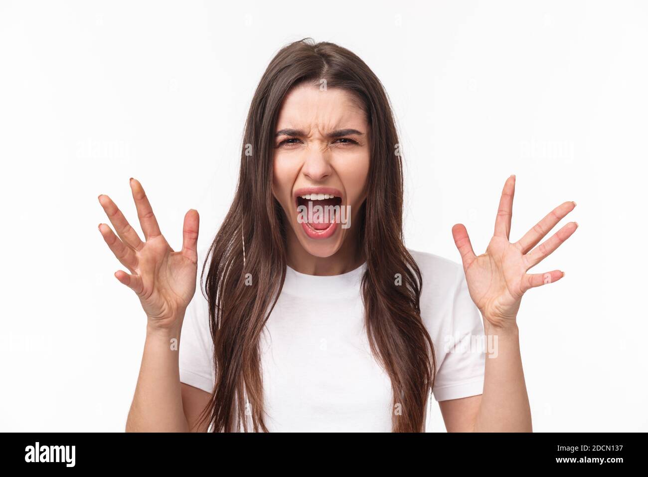 Close-up portrait of angry, pissed-off aggressive woman screaming at ...