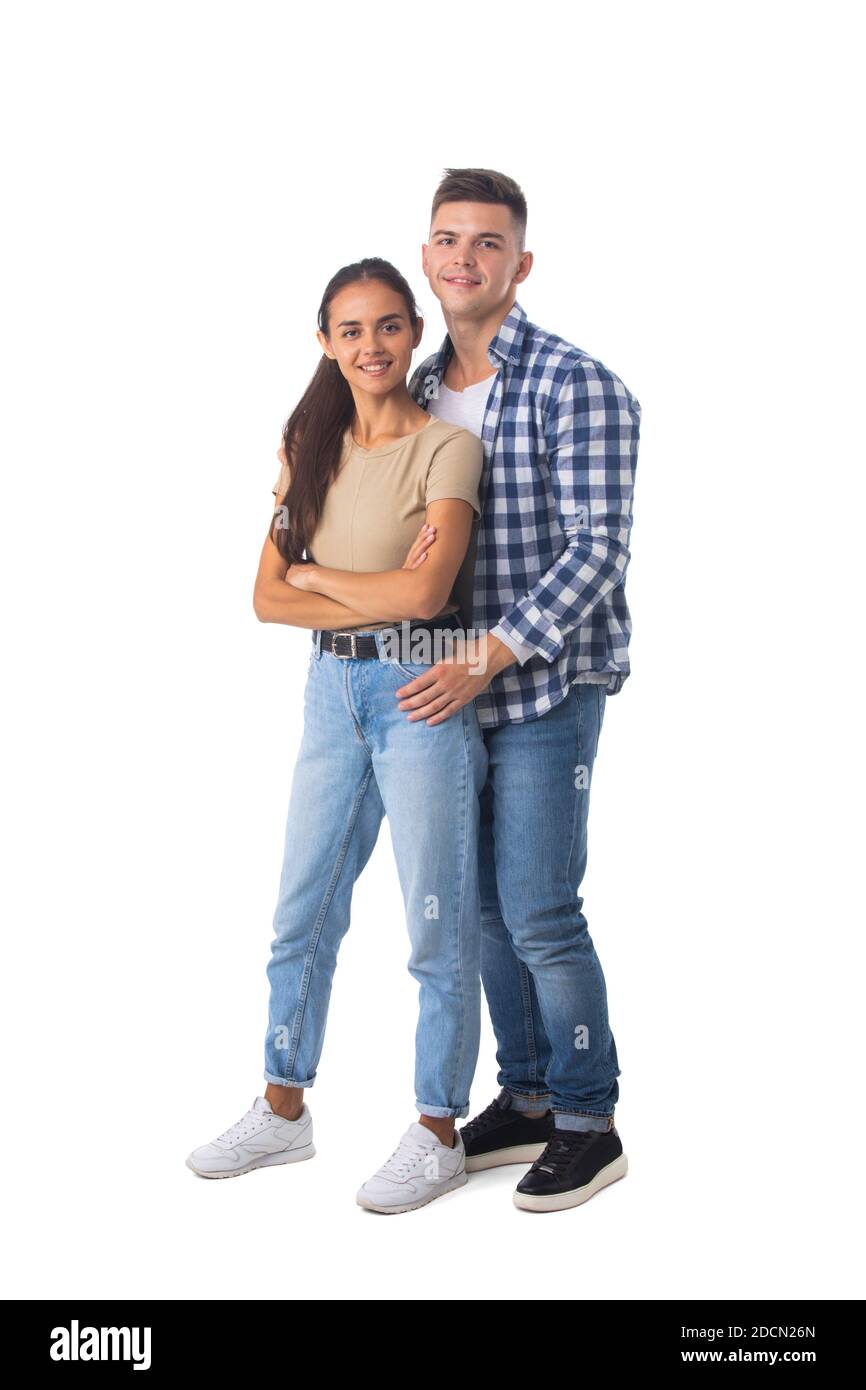 Smiling young couple embracing and standing full length isolated on ...