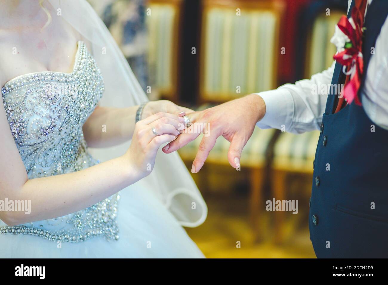 A view of bride placing the wedding ring on the fourth finger of the ...