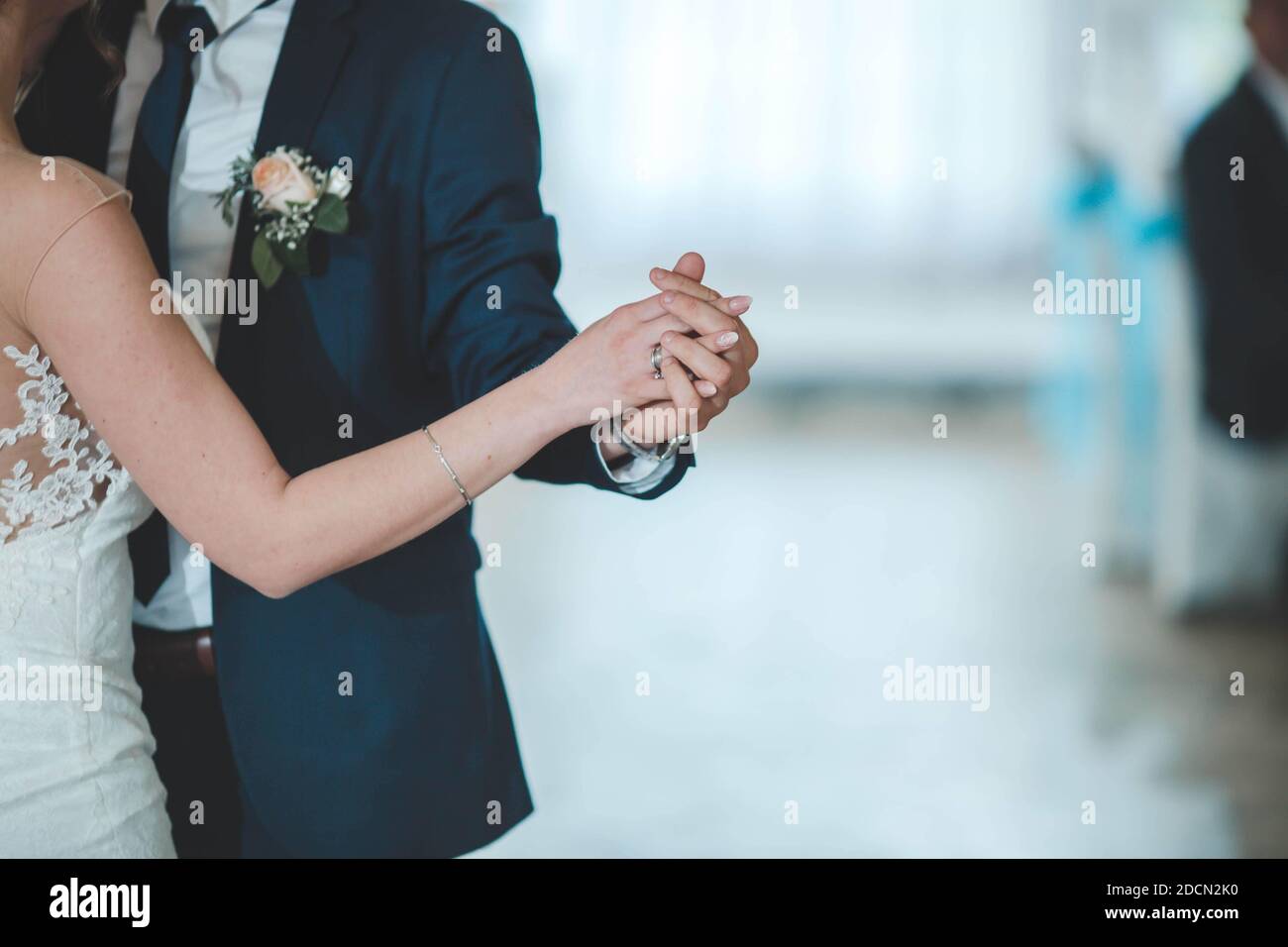 A closeup view of the bride and the groom dancing during their wedding ...