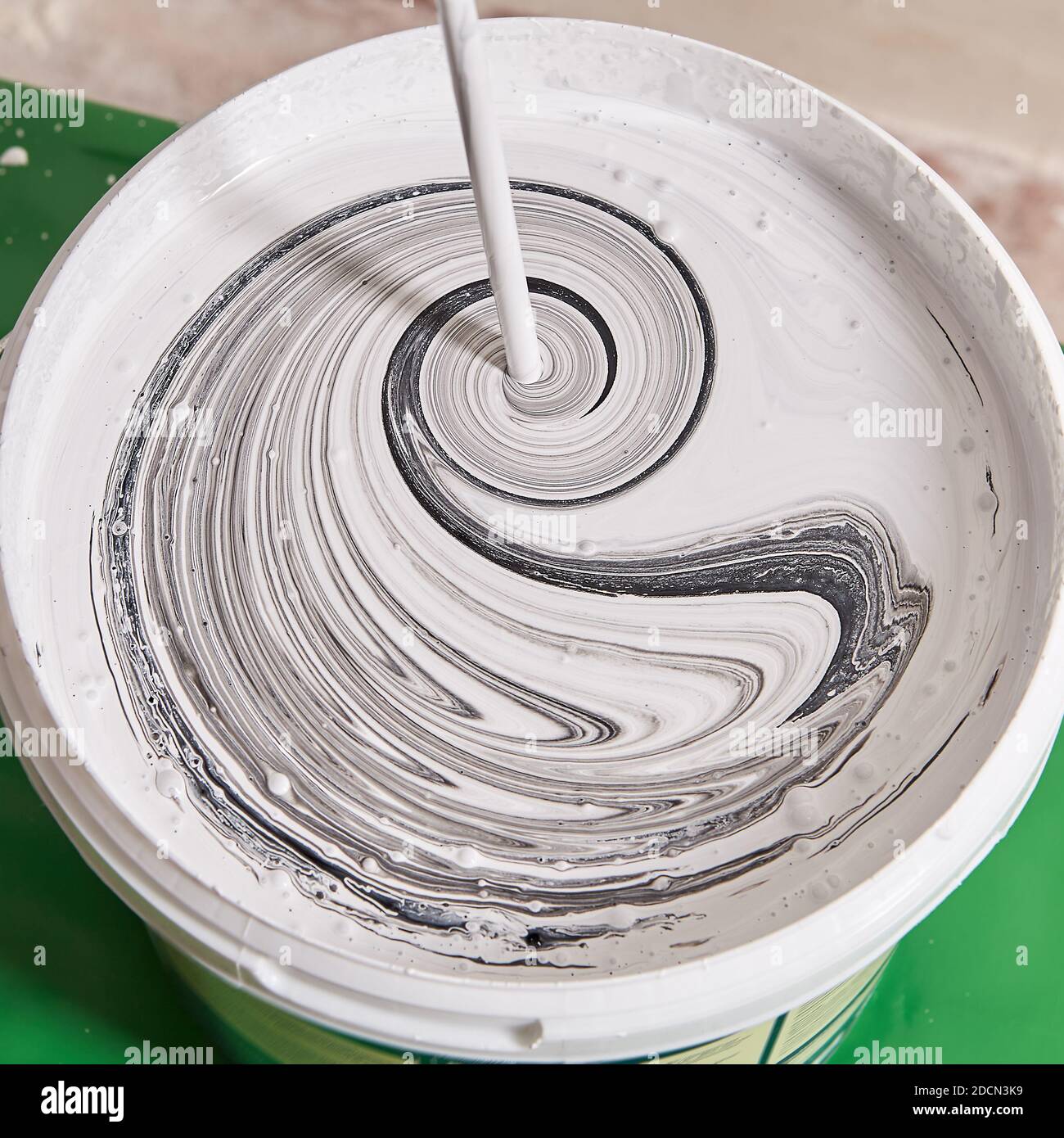 Handyman makes color for coloring wall in room while renovation Stock ...