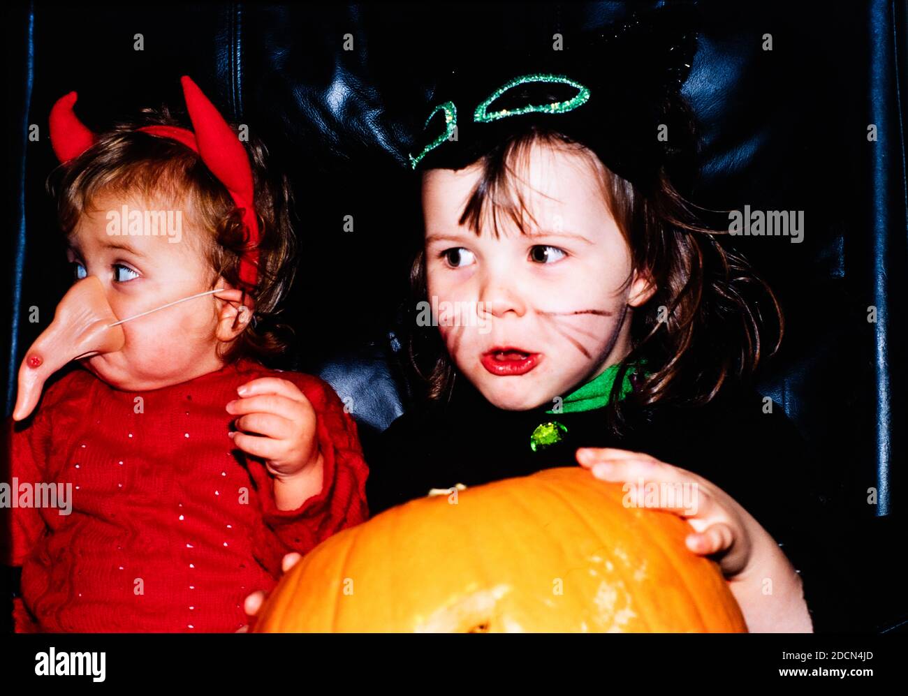 Two children dressed for Halloween with a pumpkin, UK Stock Photo - Alamy