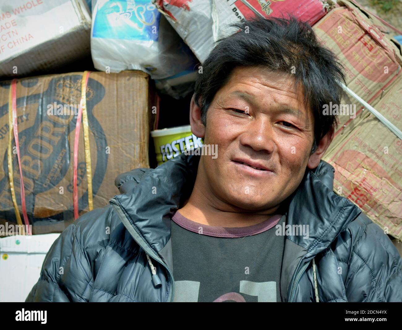 Young Nepali Rai trader poses for the camera in front of his ...