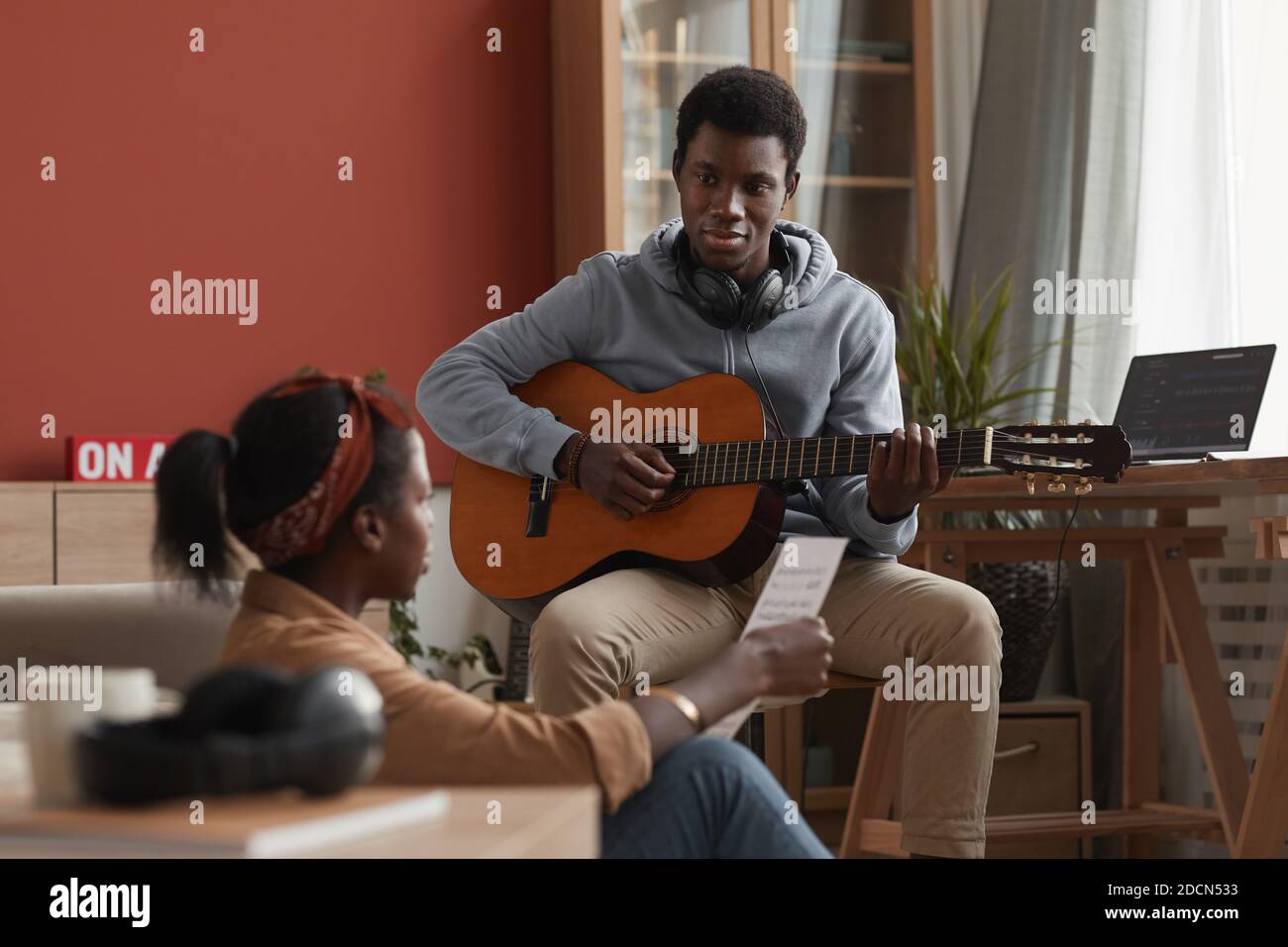 Portrait of two young African-American musicians playing guitar and ...