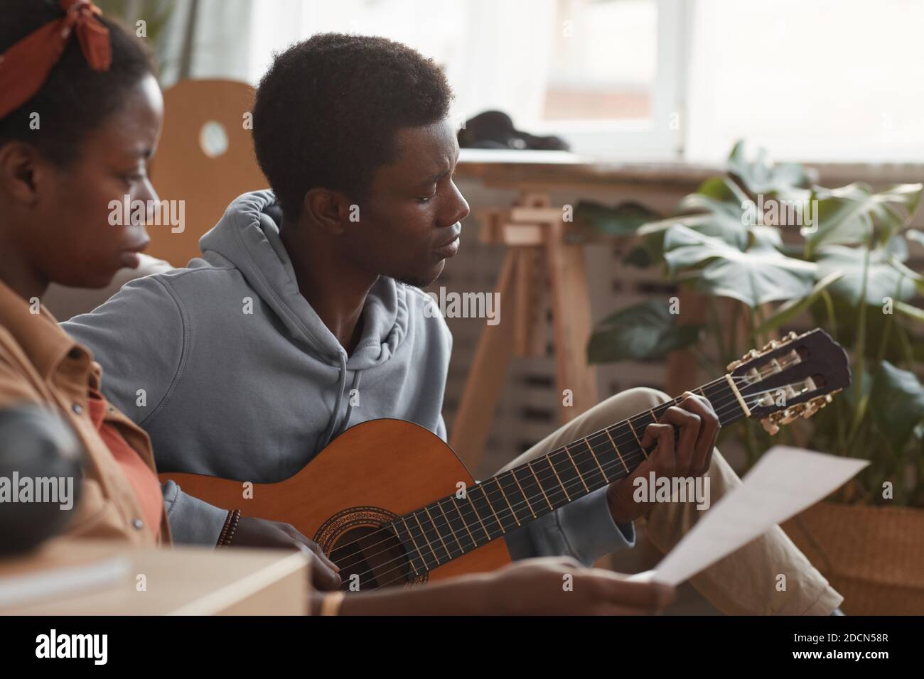 Side view portrait of two young African-American musicians playing ...