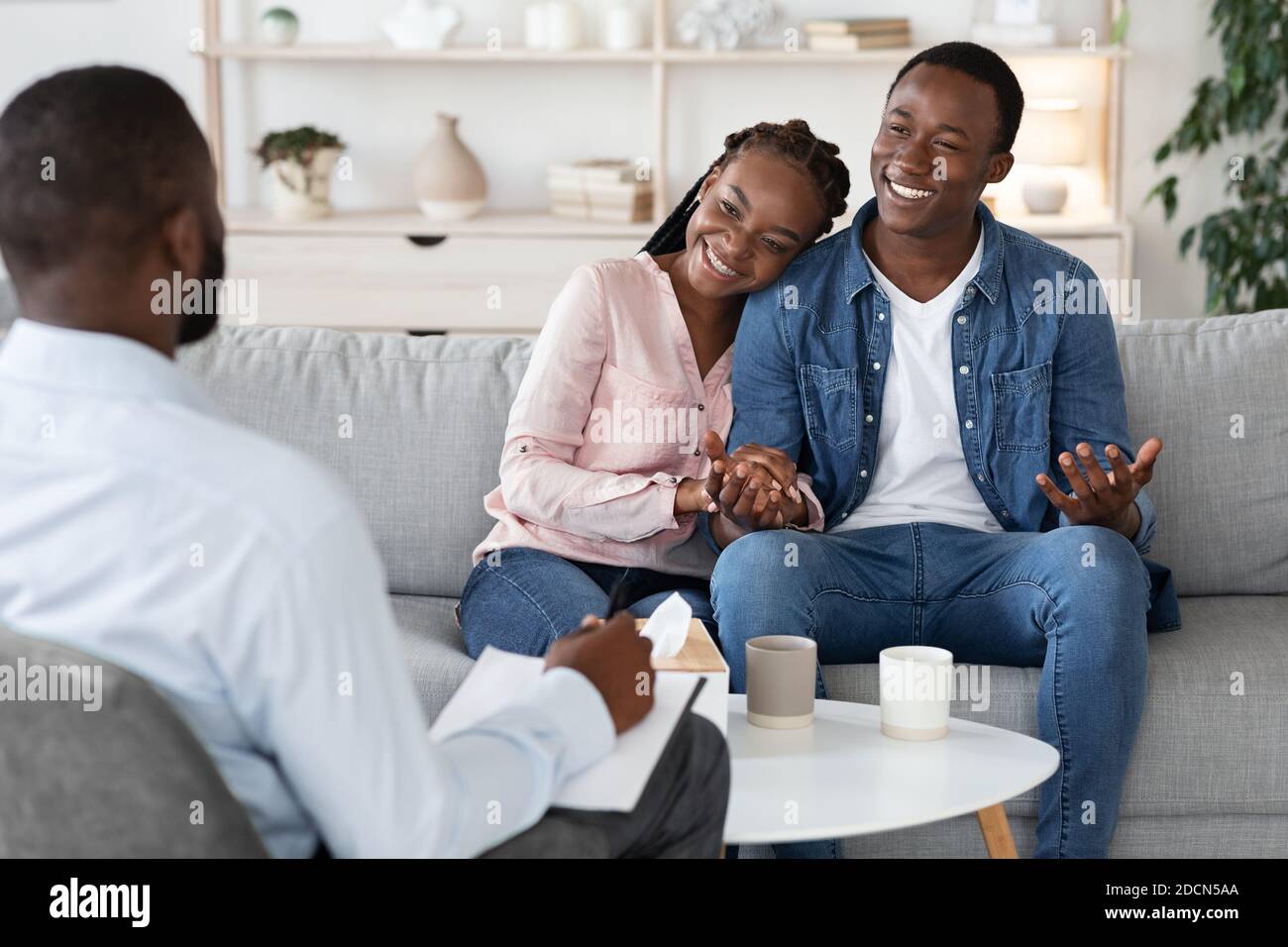 Family Counseling. Young Happy Black Couple Sitting On Couch At ...
