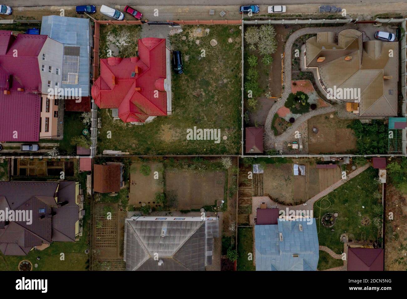 Aerial top view of a private house with paved yard with green grass ...