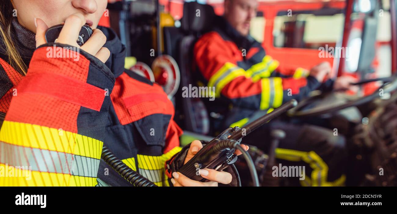 Fire fighter woman on duty using the radio Stock Photo - Alamy