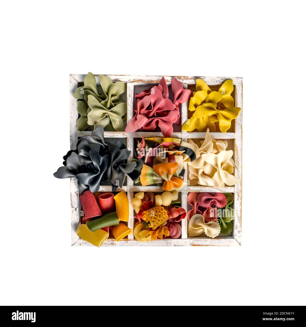 wooden box with various types of Italian pasta on a white table ...