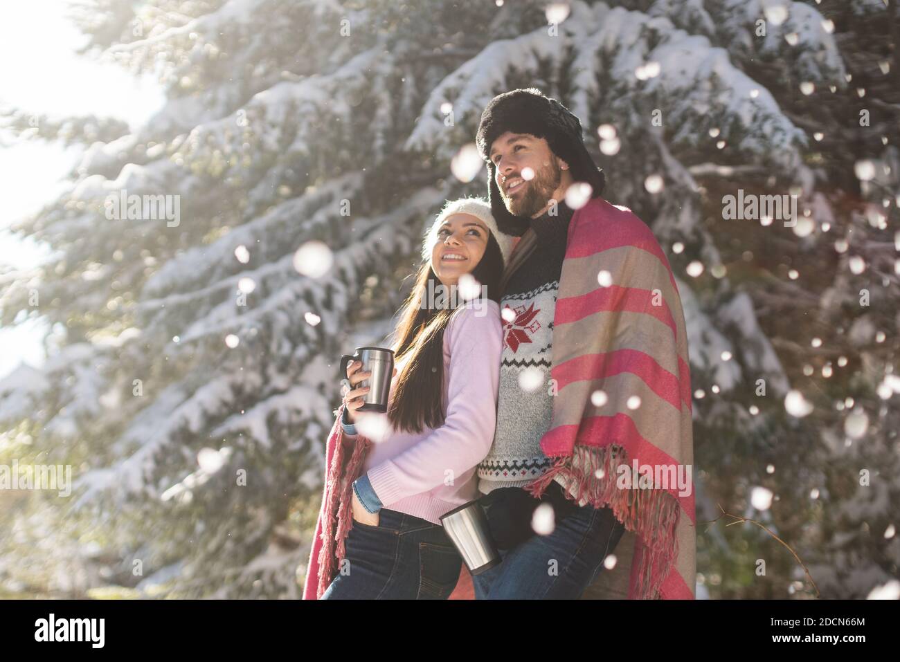 Couple posing snowfall Stock Photo - Alamy