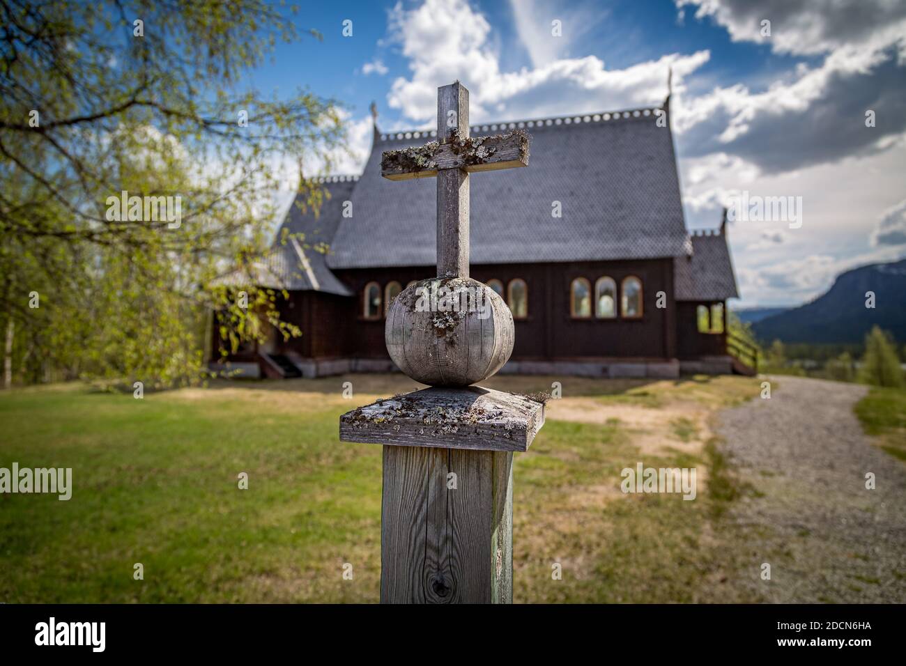 Weathered wooden cross in front of historic church in Kvikkjokk ...