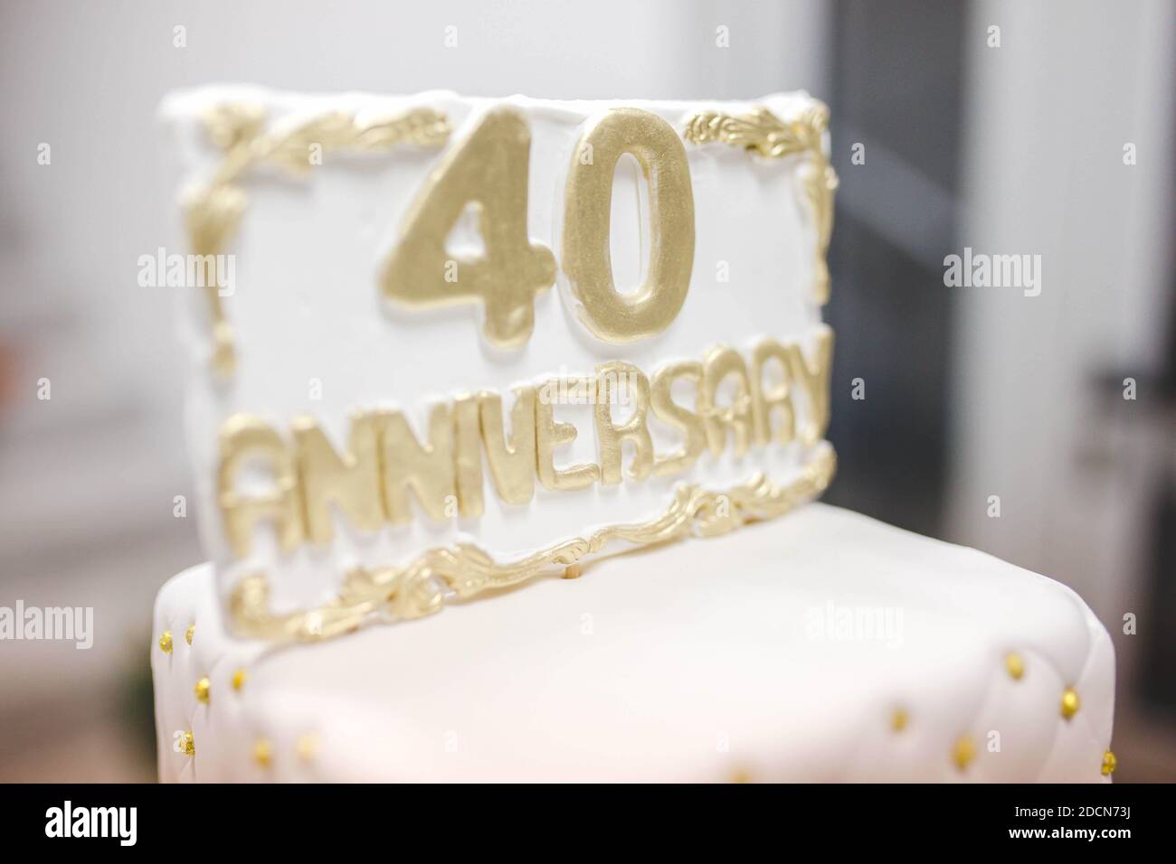 a closeup of a forty anniversary golden writing on a cake Stock Photo ...