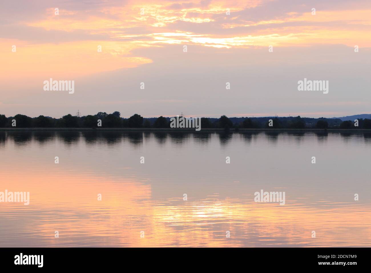A scenic pink shaded sunset on a lake Stock Photo - Alamy