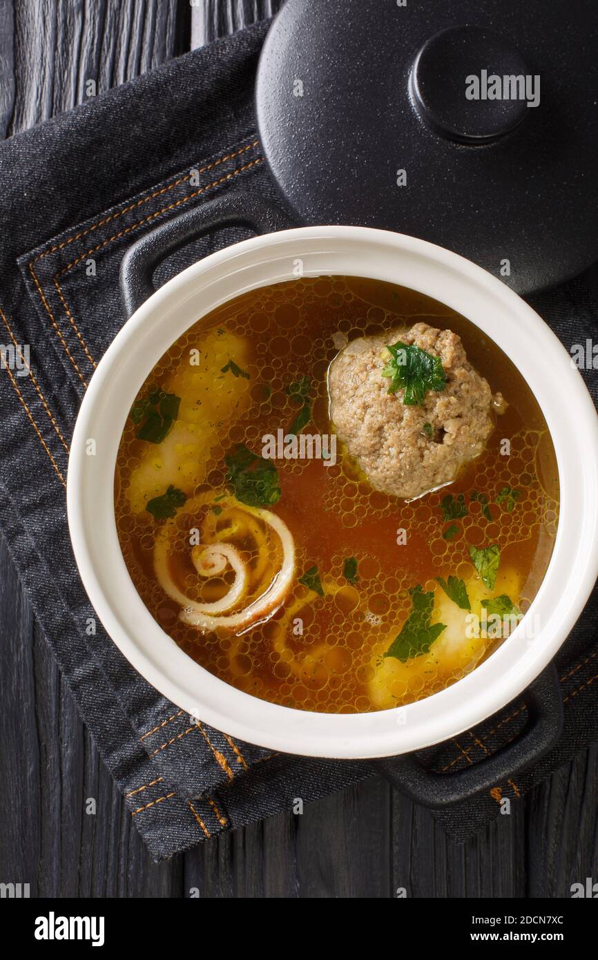 Rindsuppe Brown Beef Soup Recipe close-up in a saucepan on the table ...