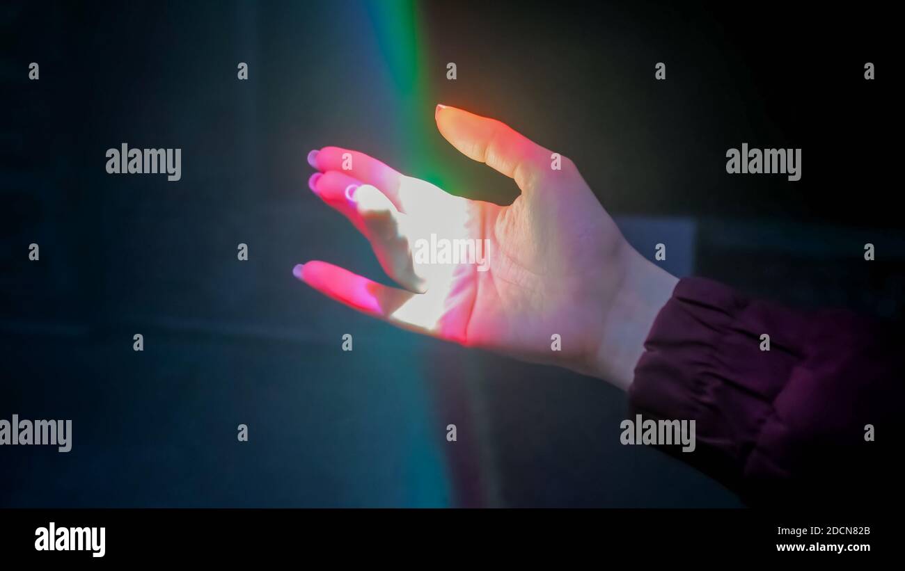 Woman moving hand under colorful laser rays - close up view - visuals ...