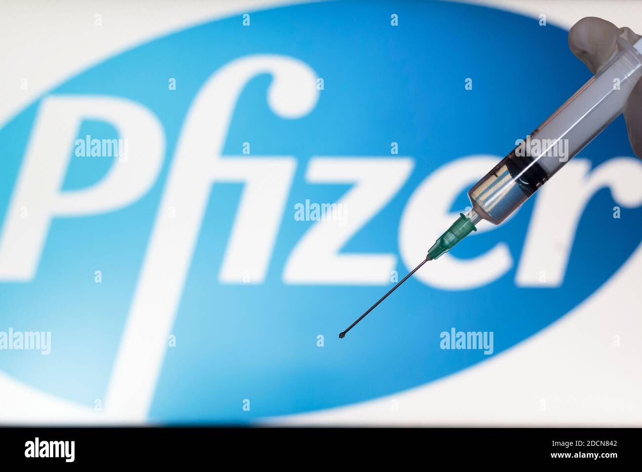 Lisbon, Portugal - November 22, 2020: Syringe and Pfizer logo on the ...