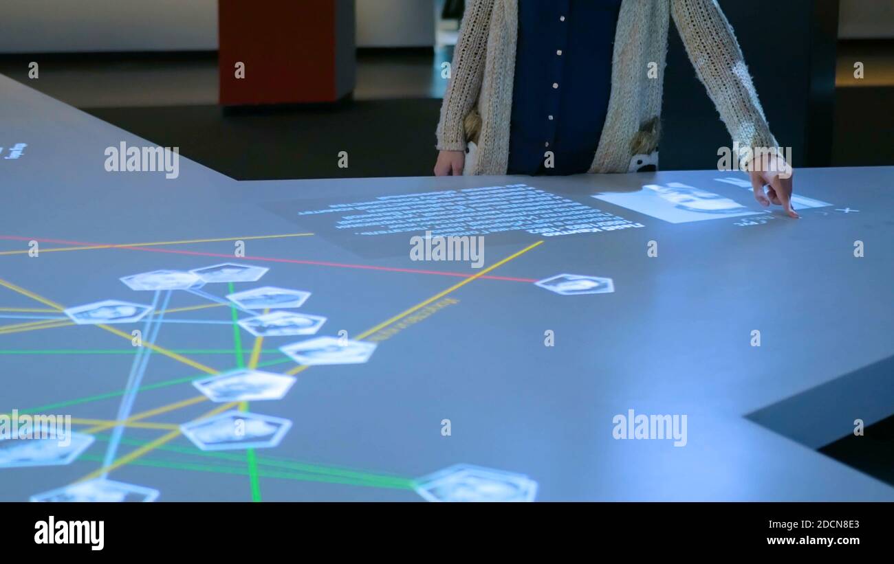 Woman using interactive touchscreen display Stock Photo - Alamy